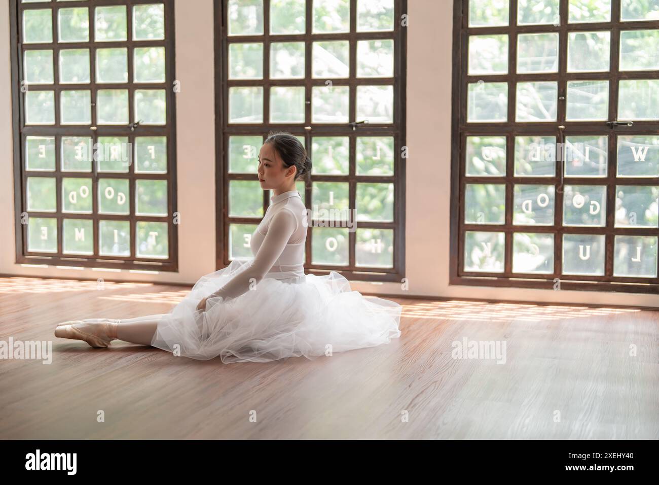 Asian girlÂ ballet dancer gymnastic exercises in studio for body ...