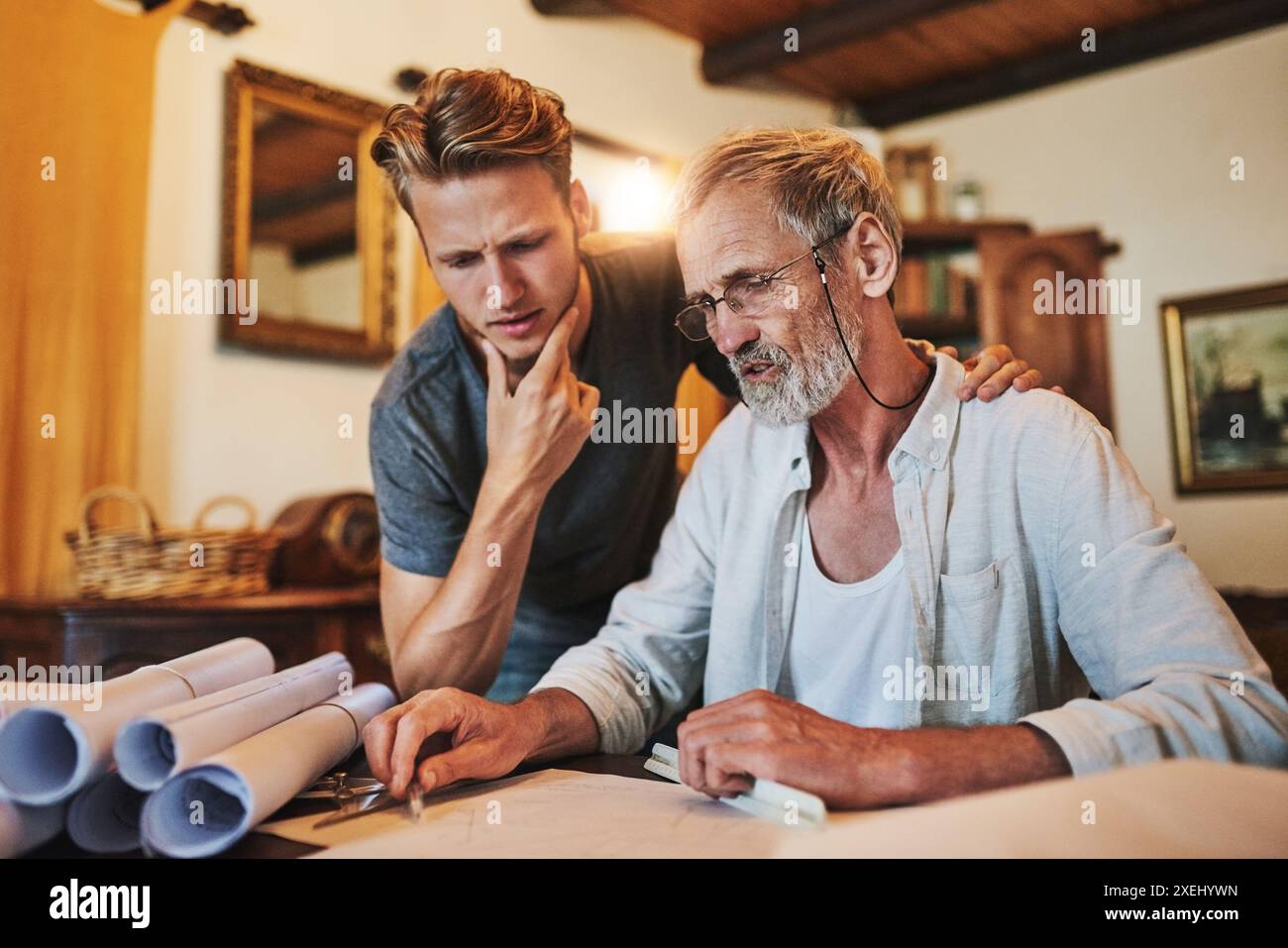 Senior engineer, apprentice and blueprint for project design ...