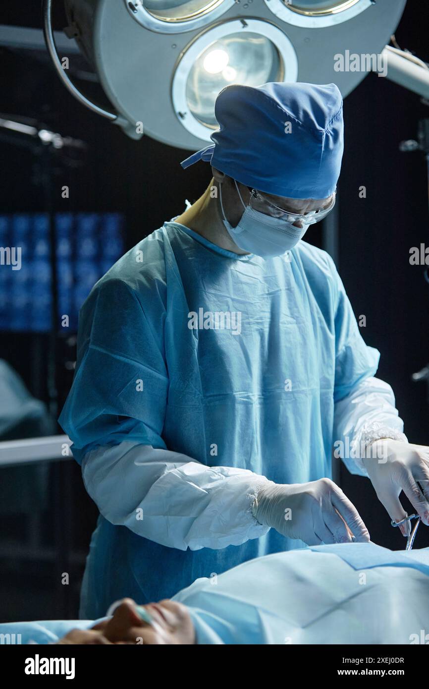 Vertical portrait of male surgeon wearing full protective clothing ...