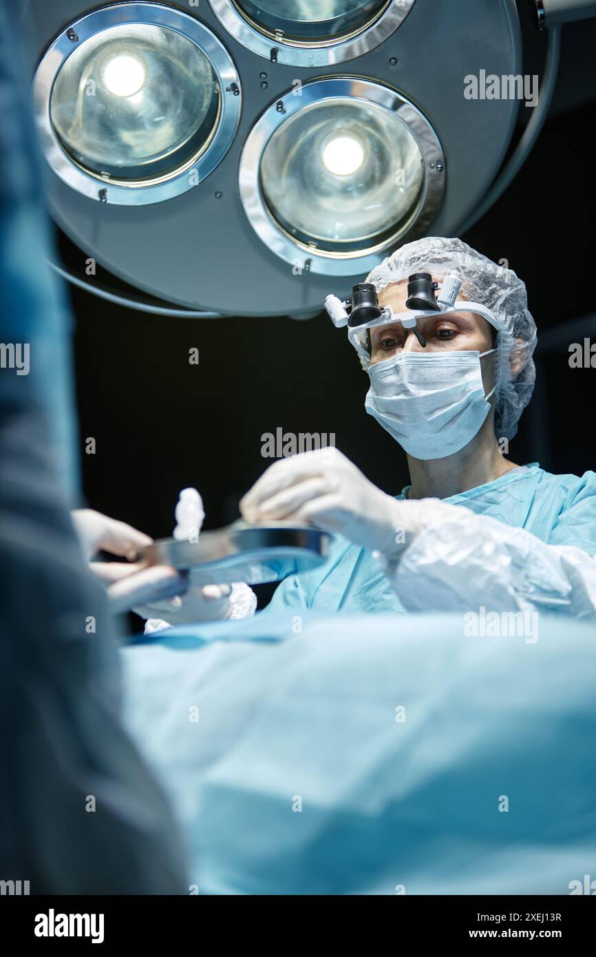Vertical low angle portrait of mature female surgeon performing ...