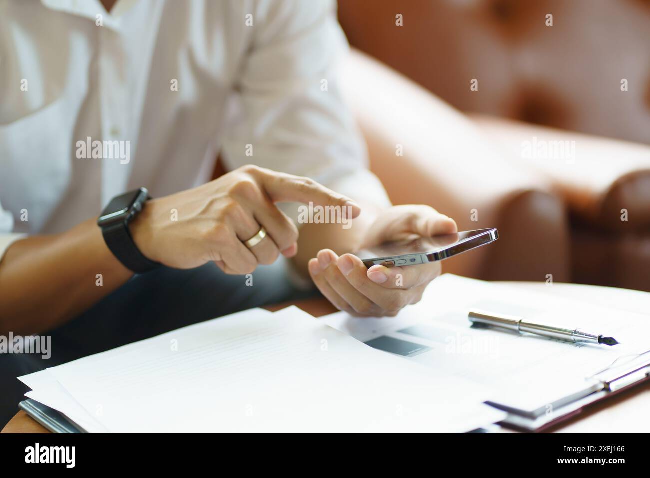 Young business man holding SmartphoneÂ working mobile devices. cell ...