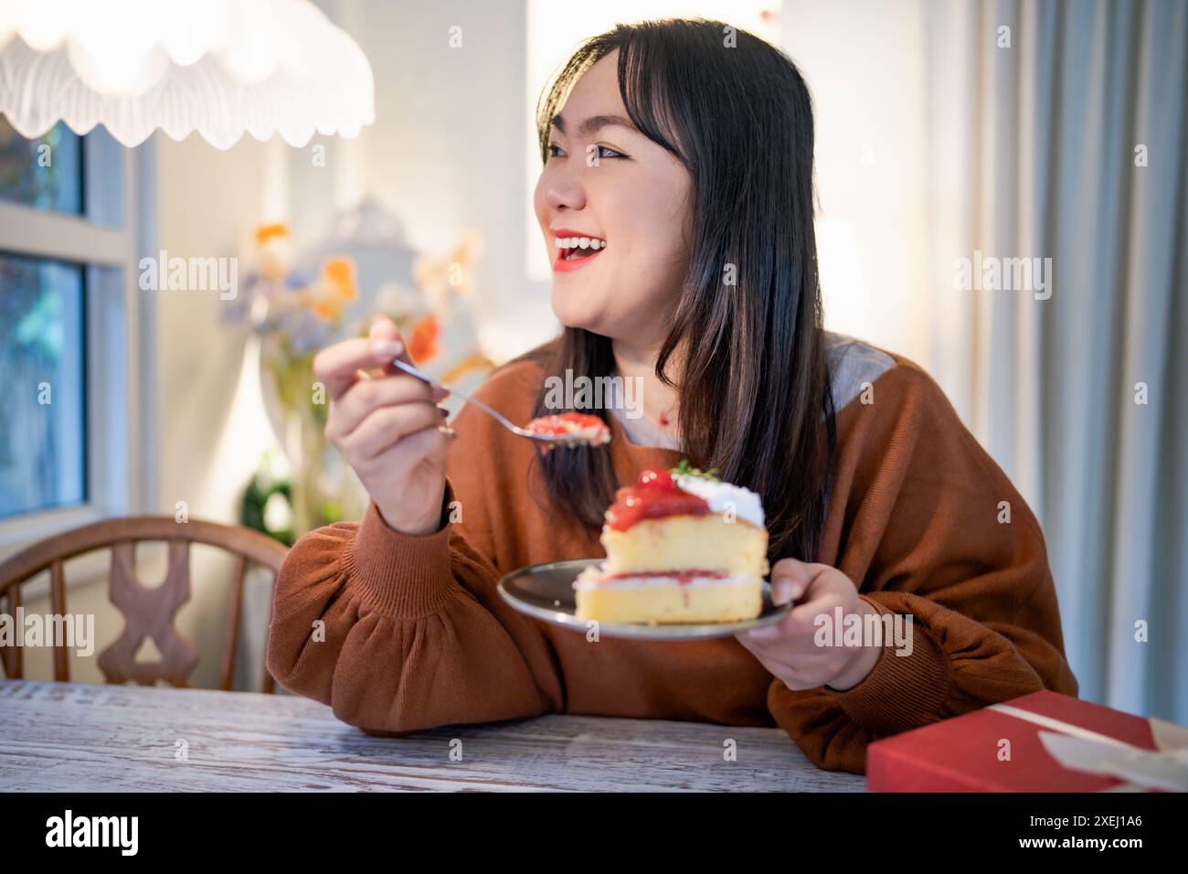 Attractive woman eating cake hi-res stock photography and images - Alamy