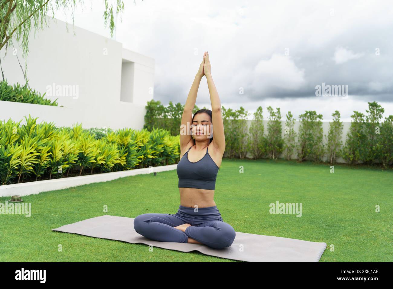BeautifulÂ confident asian woman practices yoga Â in green park relax ...
