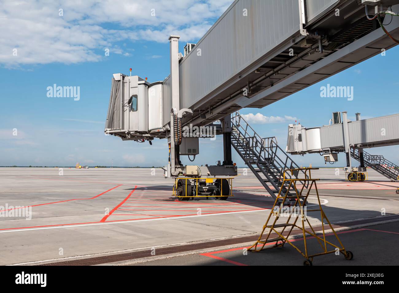 Empty passenger air bridges at airport apron Stock Photo - Alamy