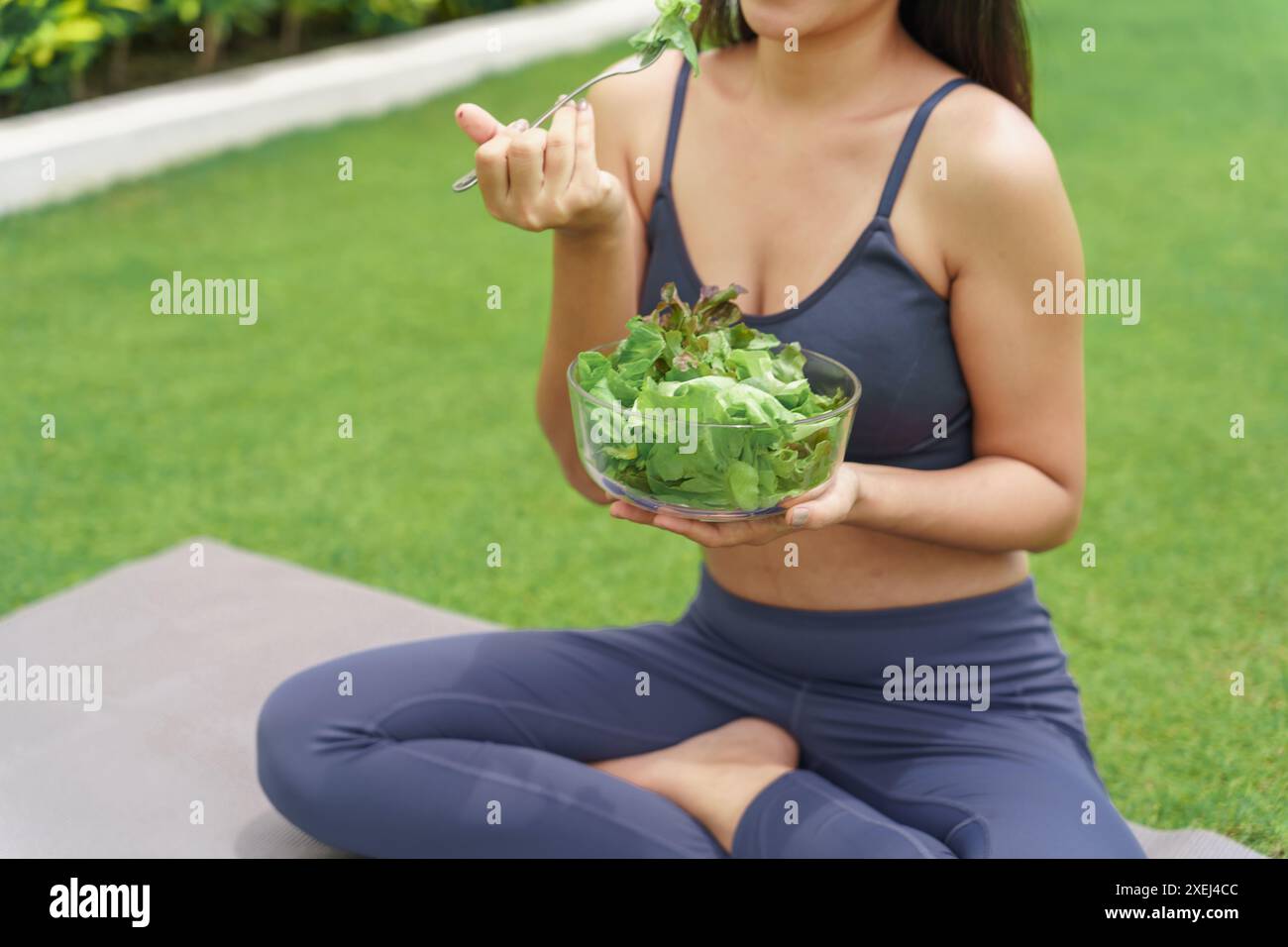 BeautifulÂ confident Fitness asian woman eating healthy salad after ...