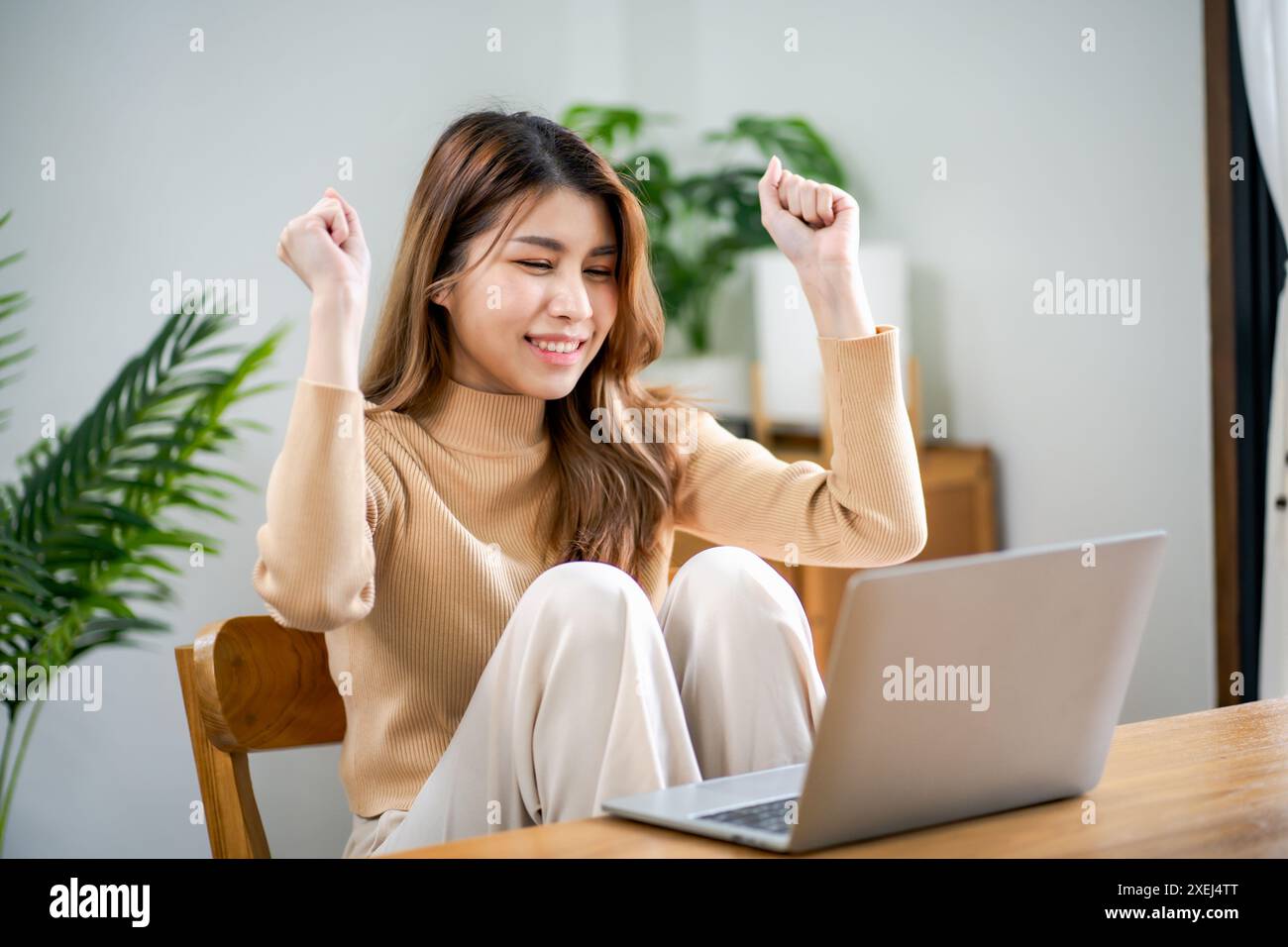 Happy young Asian Woman Successful working with laptop checking happy ...