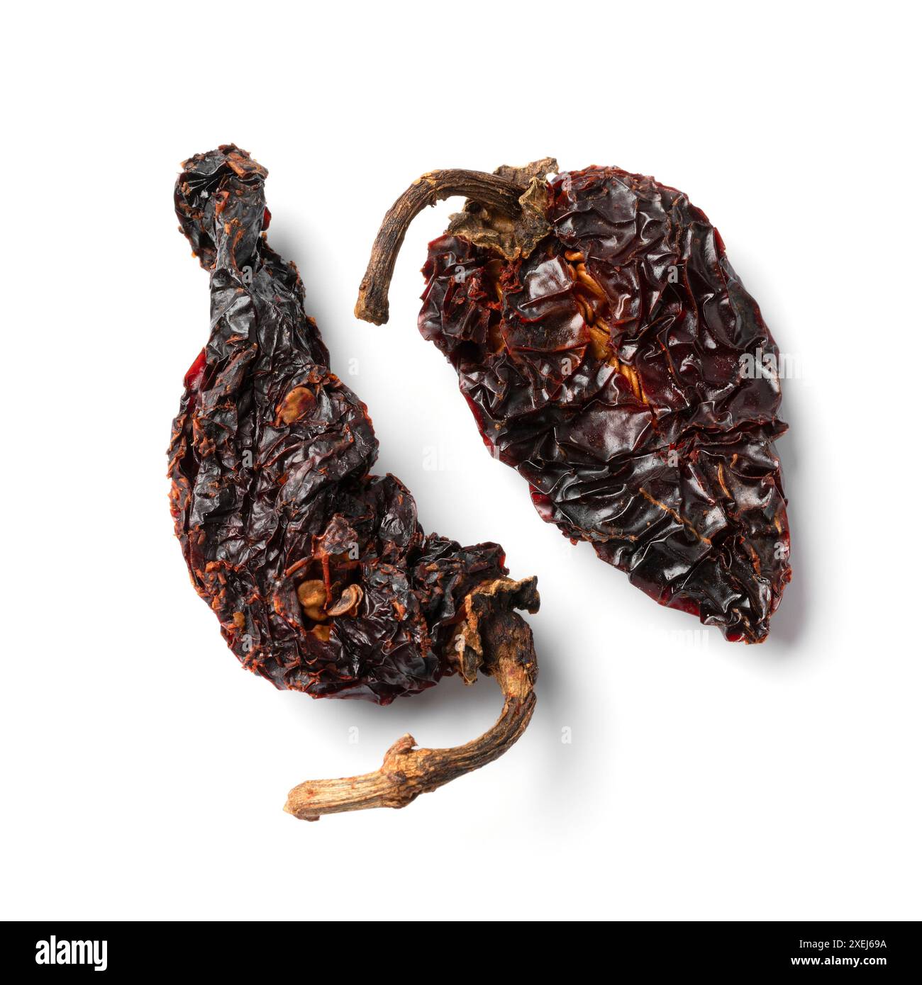 Pair of smoked Mexican chile chipotle Morita pepper close up isolated ...