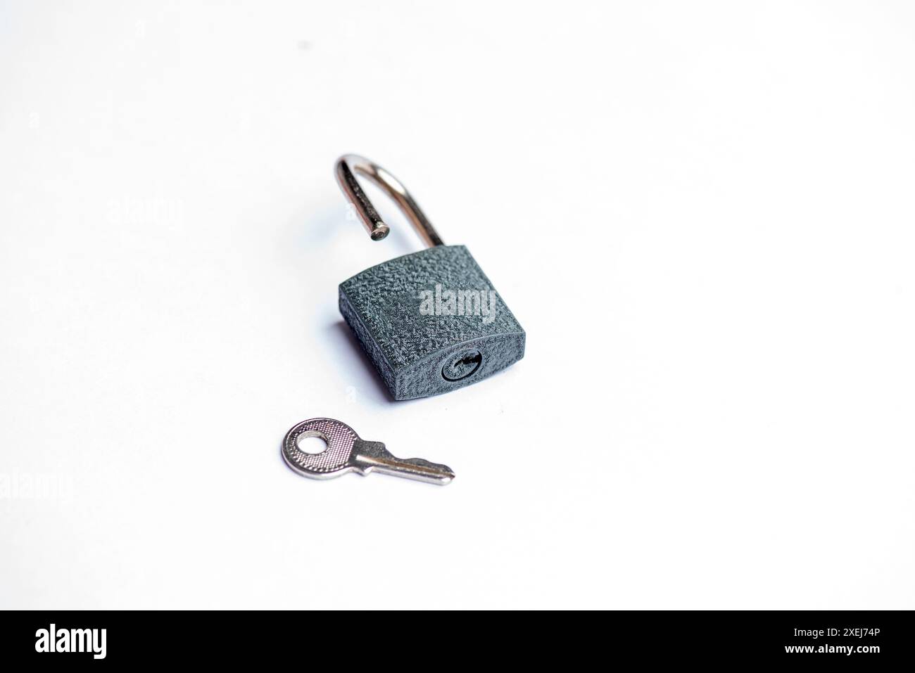 Open lock and key isolated on white background Stock Photo - Alamy