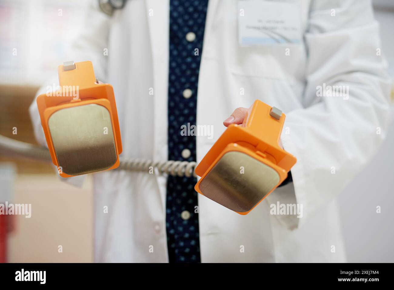 Defibrillator, hands and doctor in hospital with cardiology, electric ...