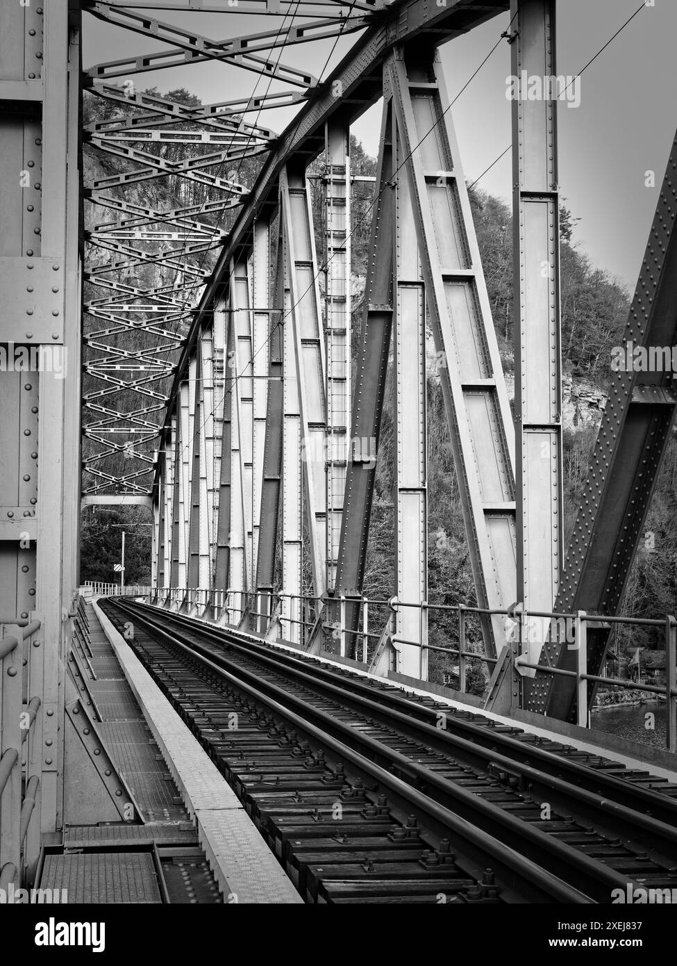A Black and white of a railway bridge with intricate steel structure ...