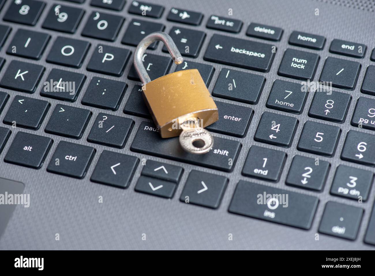 Open lock with key on computer keyboard Stock Photo - Alamy