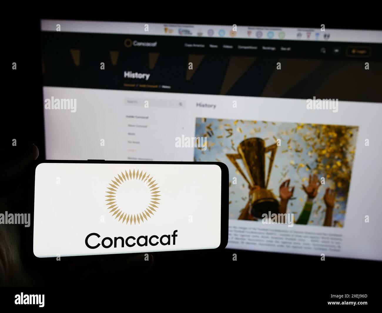 Person holding smartphone with logo of football association CONCACAF in ...