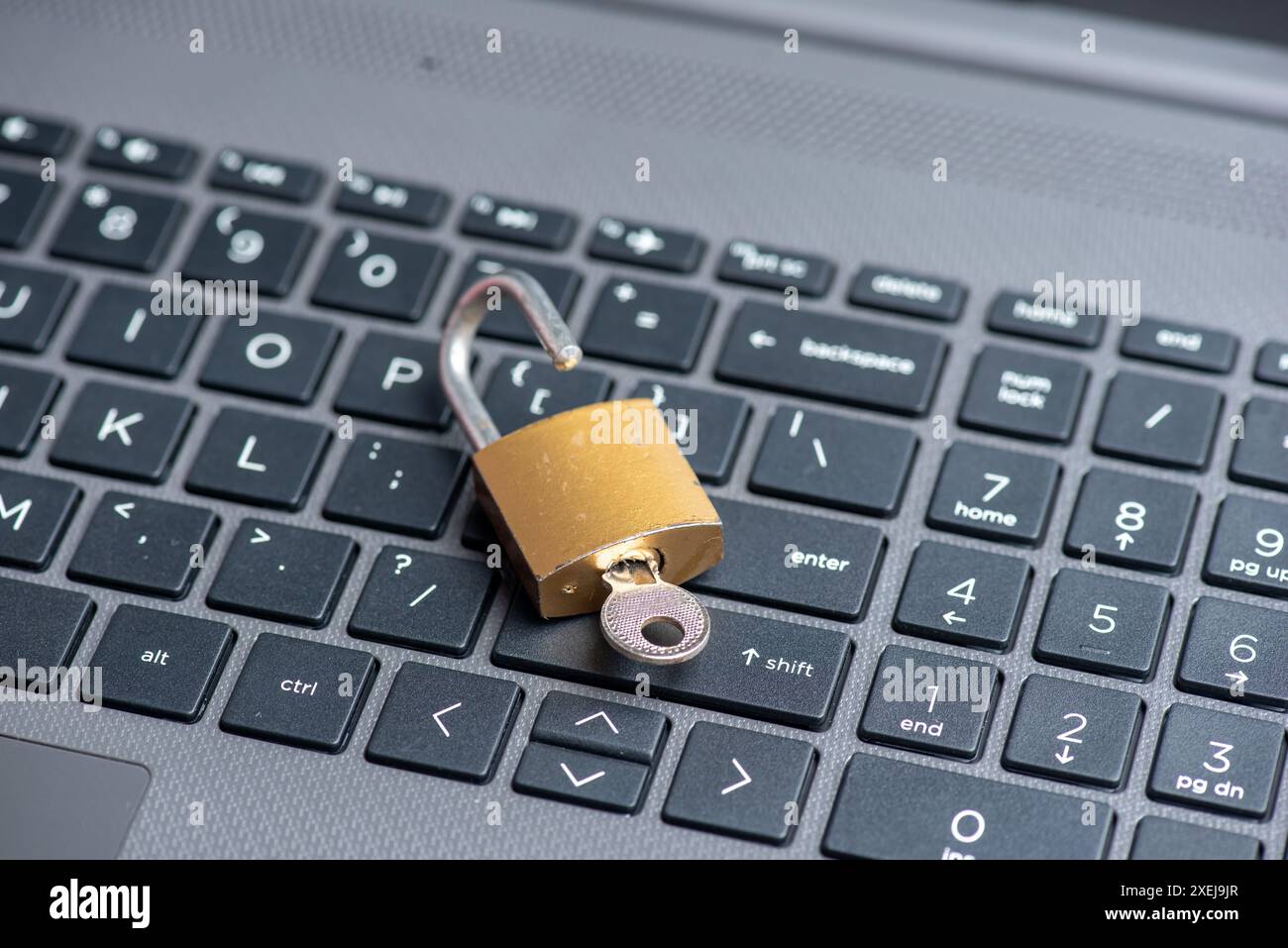 Open lock with key on computer keyboard Stock Photo - Alamy