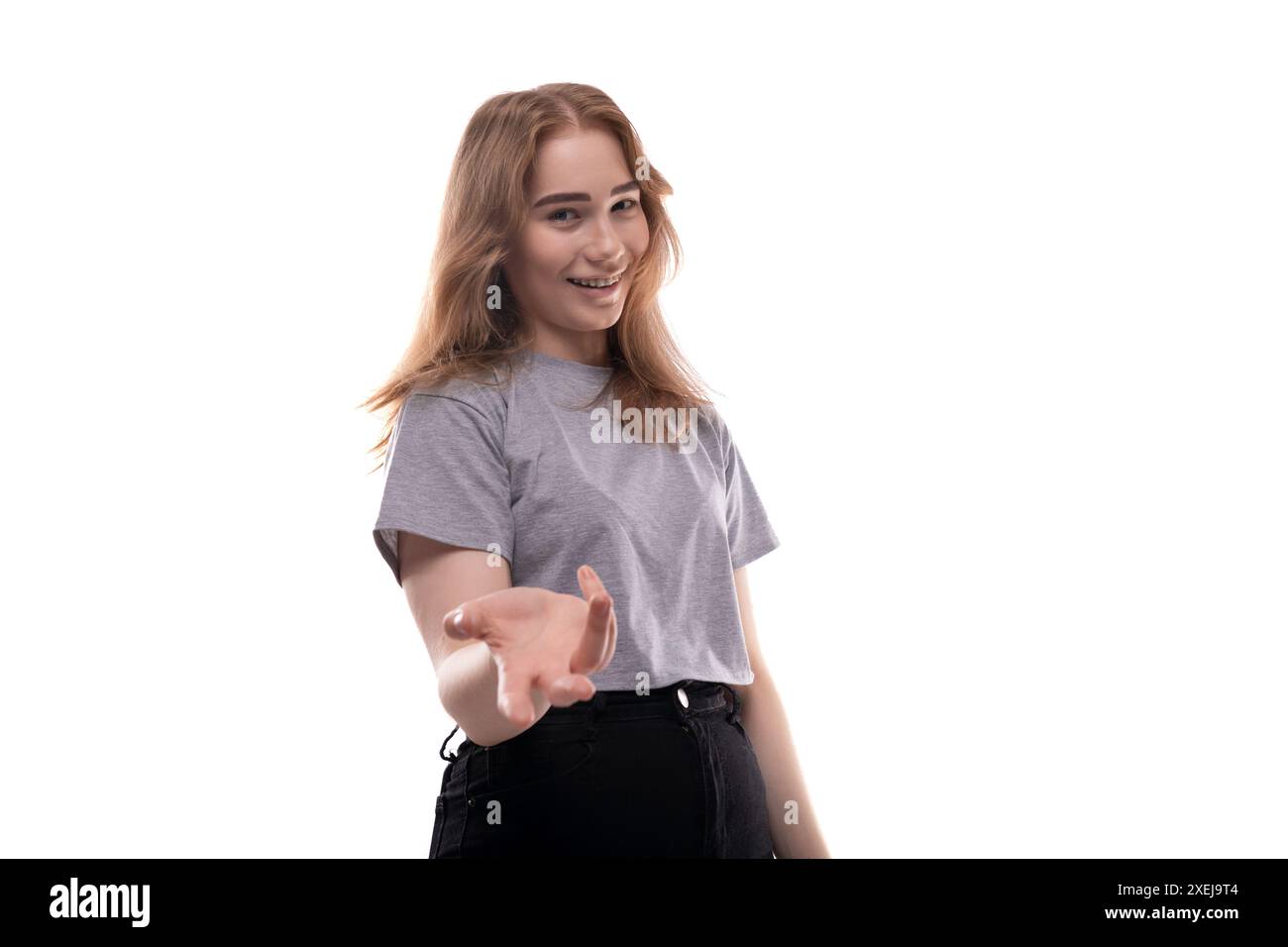 Optimist teenage girl with brown hair wearing a gray T-shirt on a ...