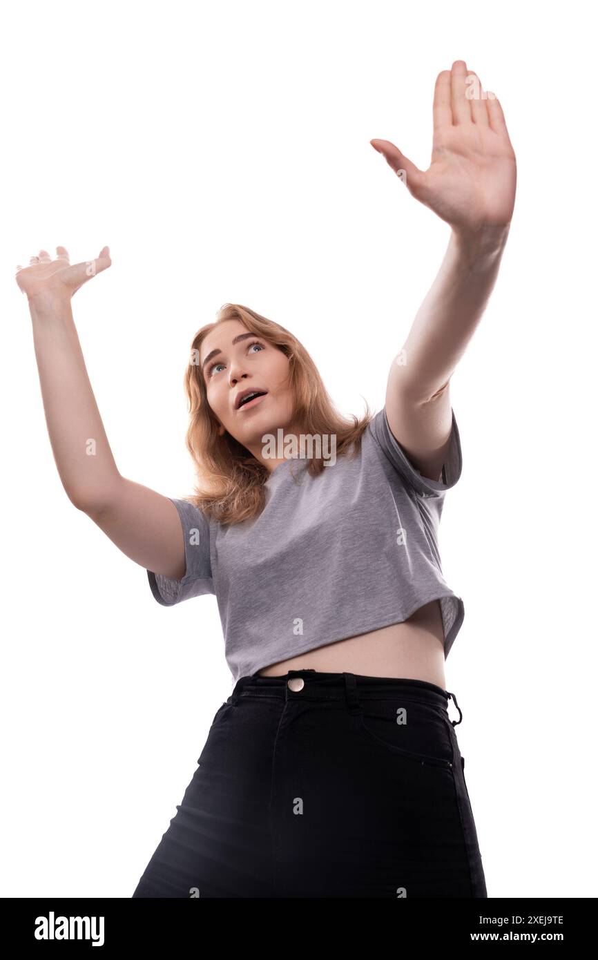 Active teenage girl waving her hands on a white background Stock Photo ...