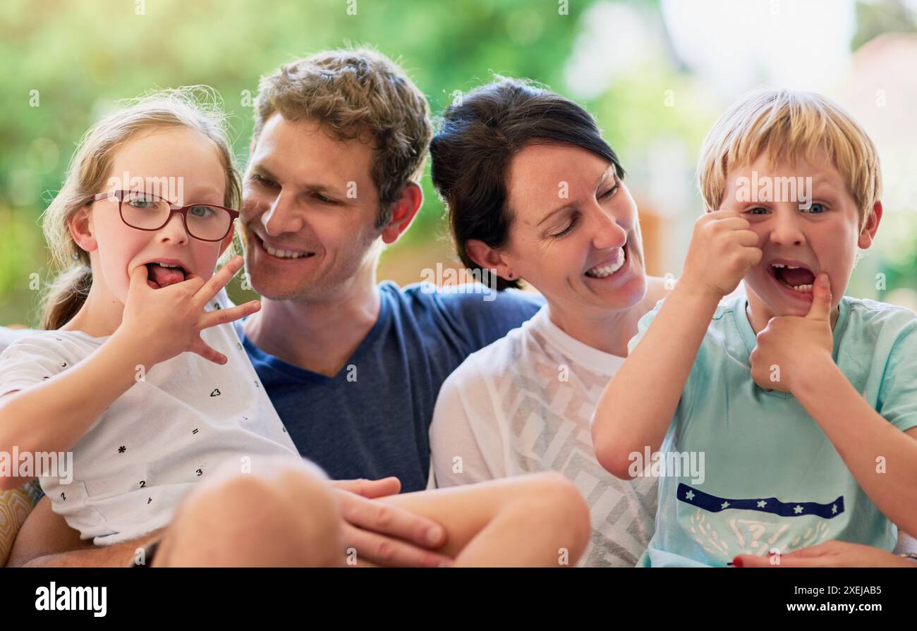Outdoor, father and mother with children in portrait, funny faces ...