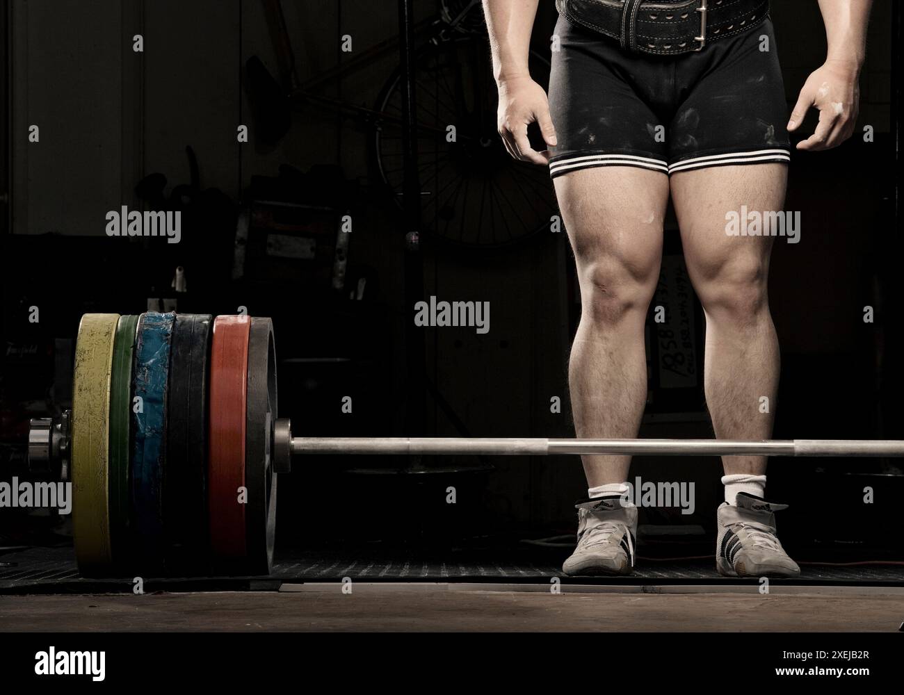The legs of a Korean male power lifter standing with weights Stock ...