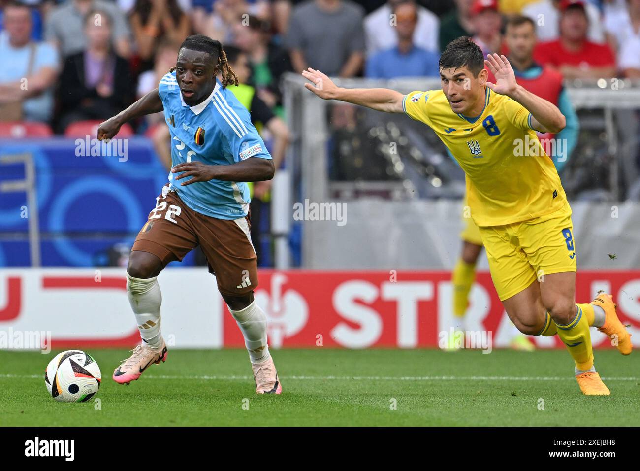 Jeremy Doku (22) of Belgium and Ruslan Malinovskyi (8) of Ukraine ...
