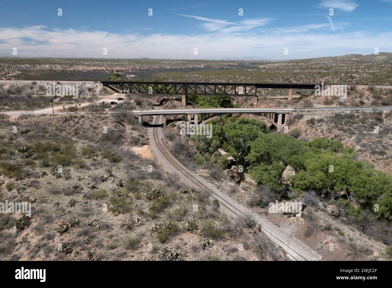 Aerial view of railroad tracks, bridge overpasses in desert landscape ...