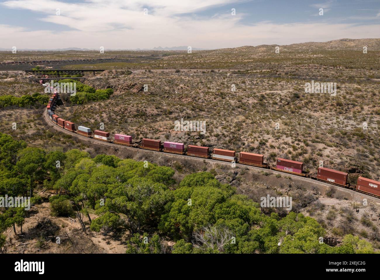 Aerial view of long container stack trains winding around curves Stock ...