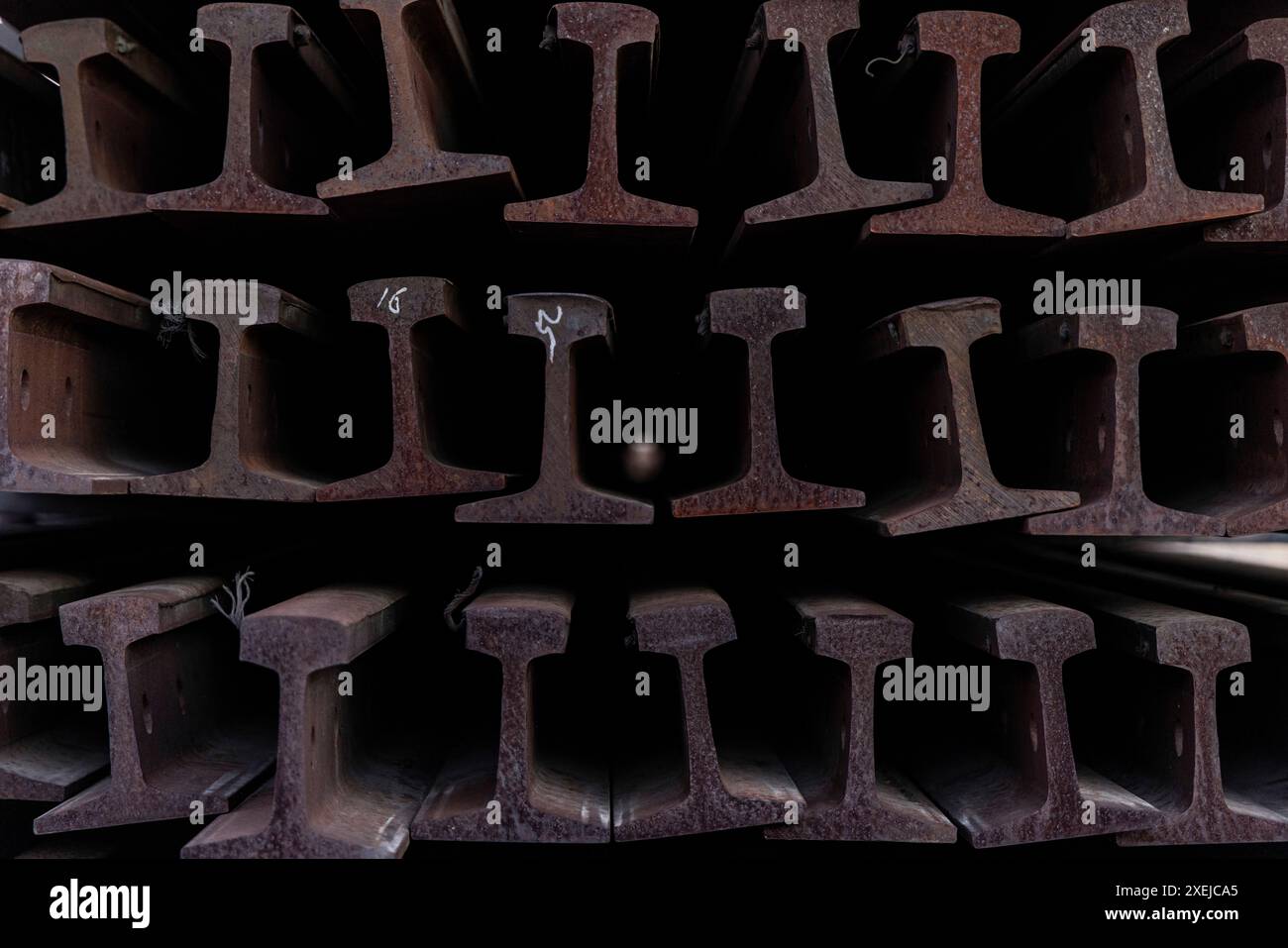 Rows of train track rails stacked in layers Stock Photo - Alamy