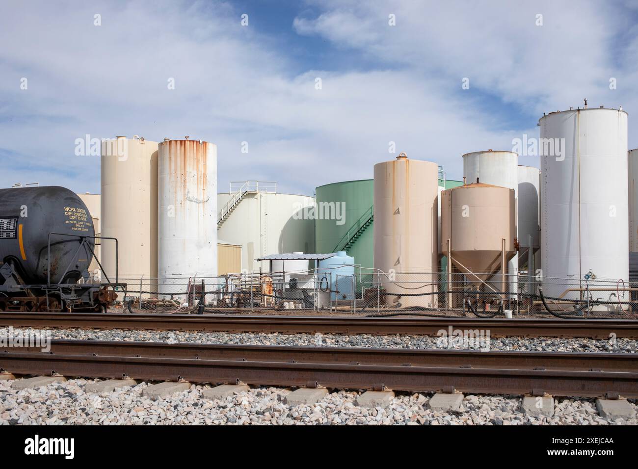 Chemical storage tanks along railroad tracks Stock Photo - Alamy