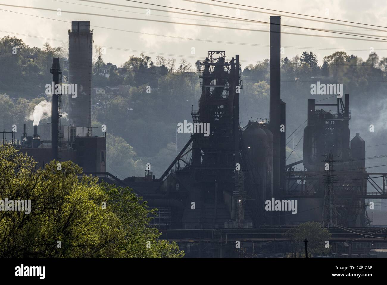 A steel mill smokes and steams in natural environment Stock Photo - Alamy