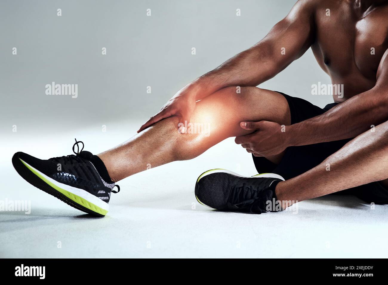 Studio, fitness and man with pain in legs, physio and calf cramp at gym ...