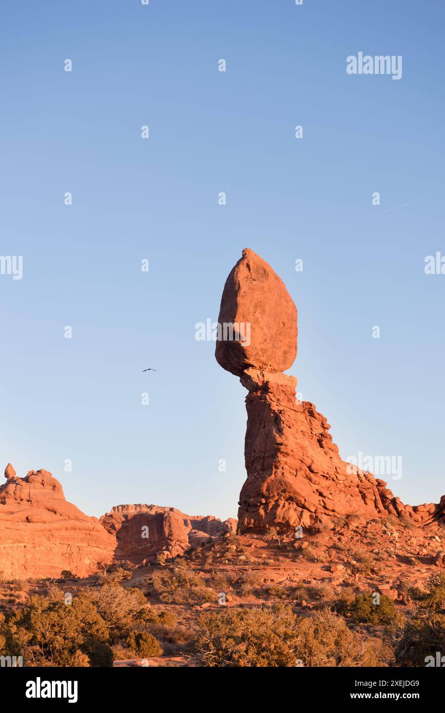 Bird flying in the distance at balanced rock arches utah Stock Photo ...