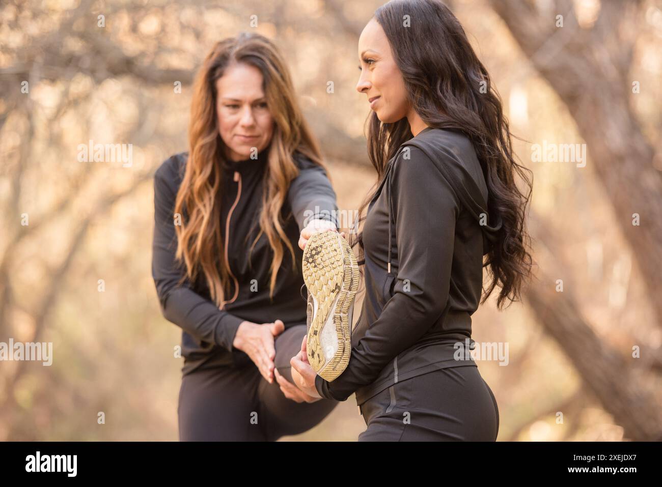 Women trainer with lady stretching Stock Photo - Alamy