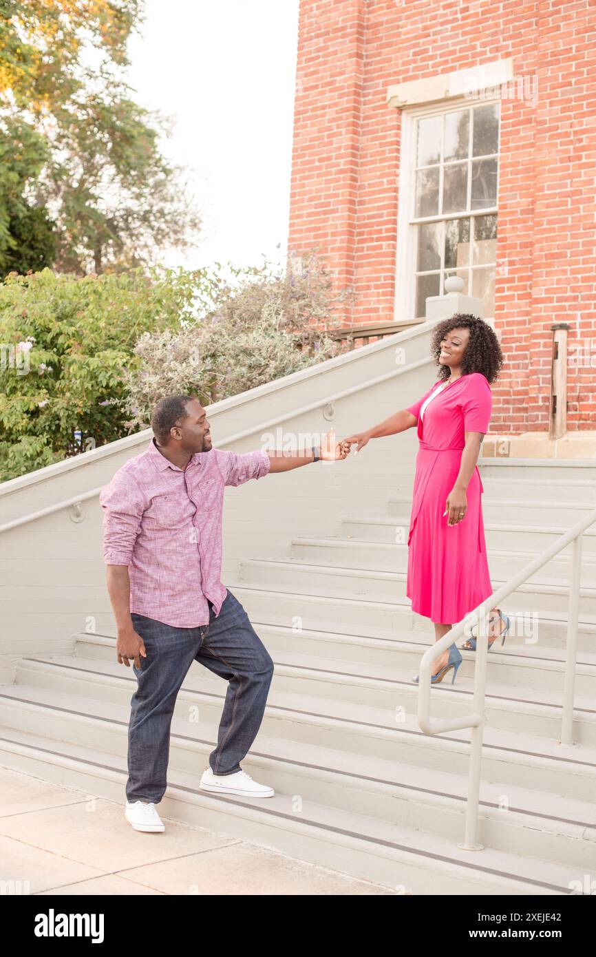 Man helping women down the steps Stock Photo - Alamy