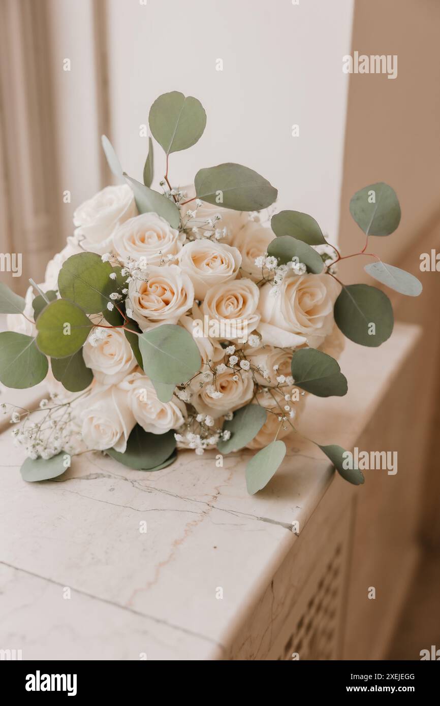 Bridal bouquet with white roses and eucalyptus on marble surface Stock ...