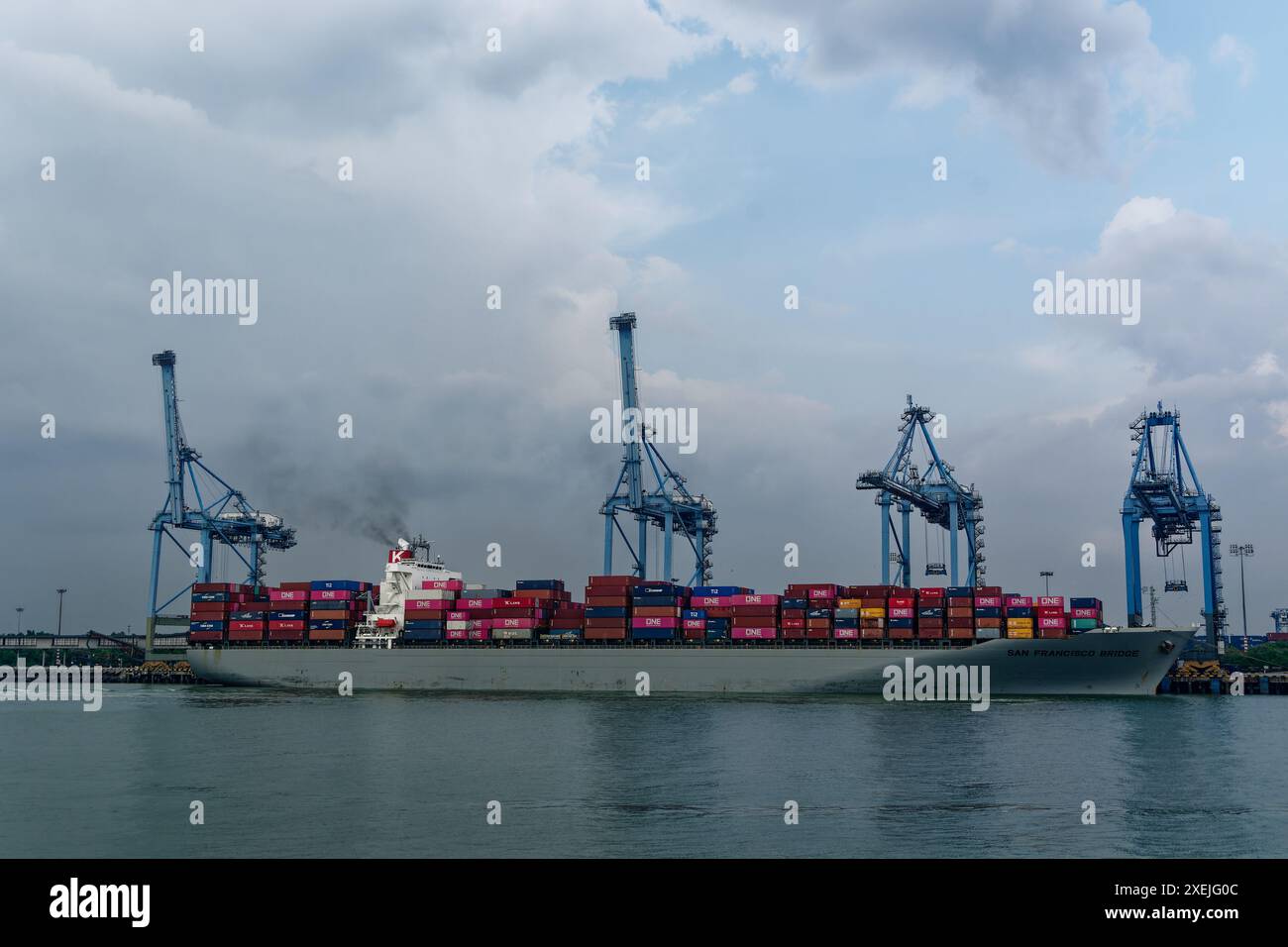 Container Cranes - four cranes with container ship moored alongsiden ...