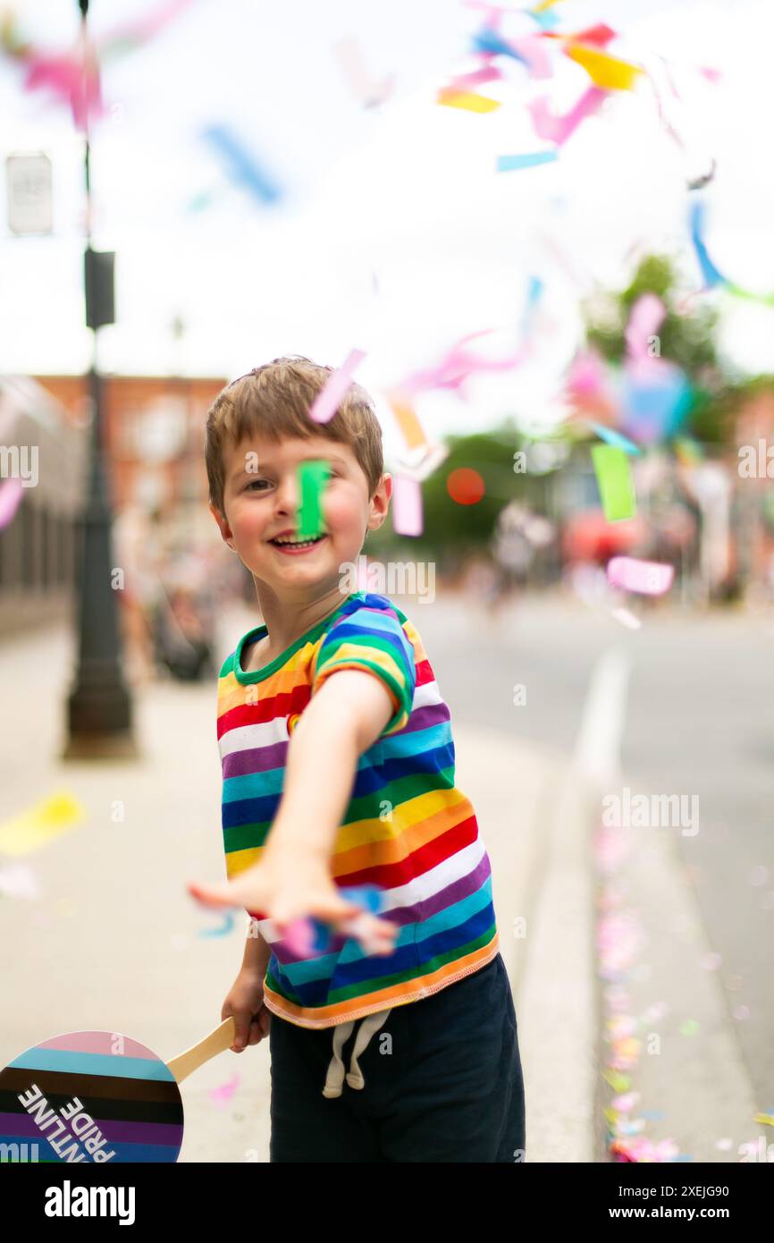 boy child throwing confetti at pride parade Stock Photo - Alamy