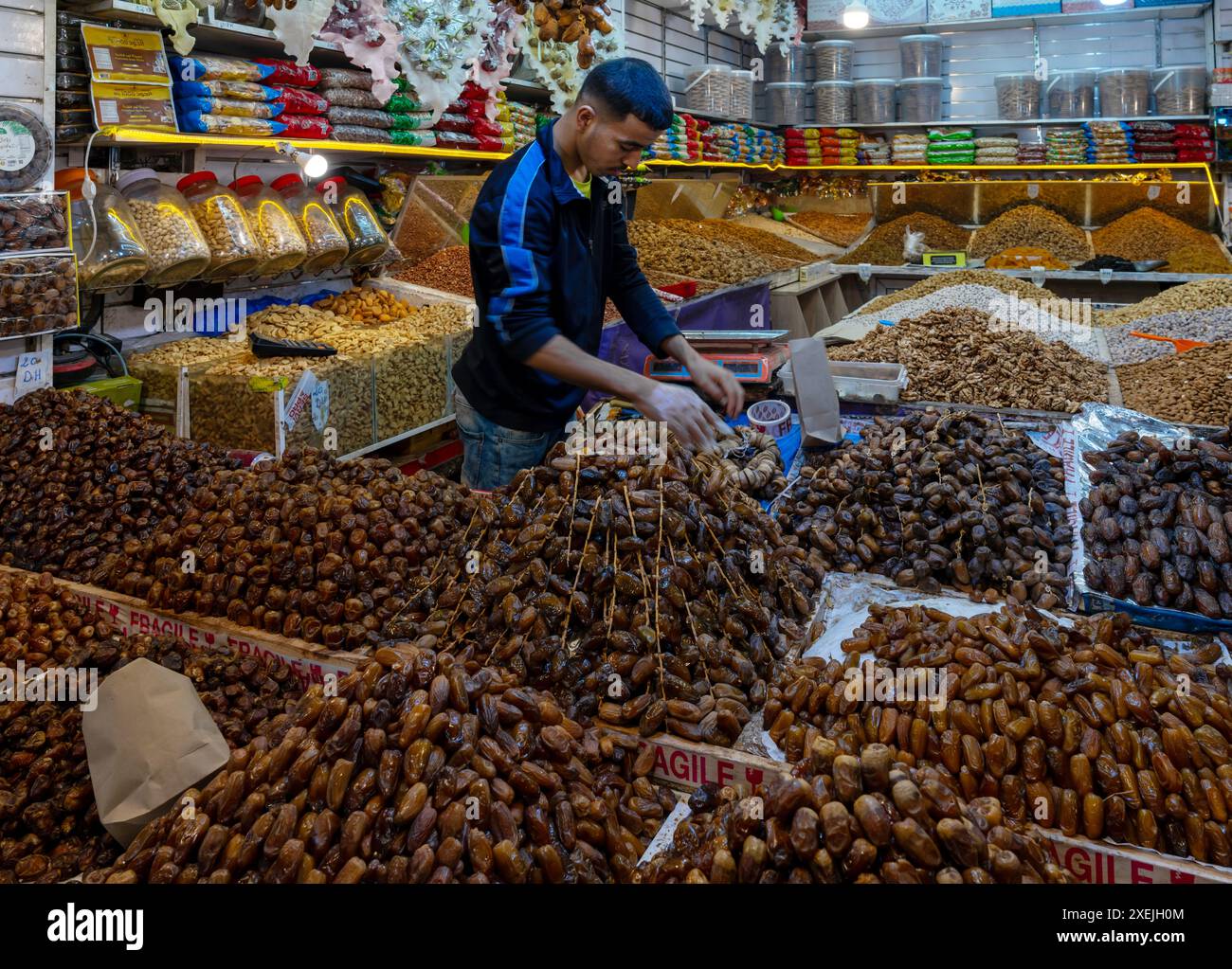 Shopkeeper selling dates and figs in the souk of the medina in ...