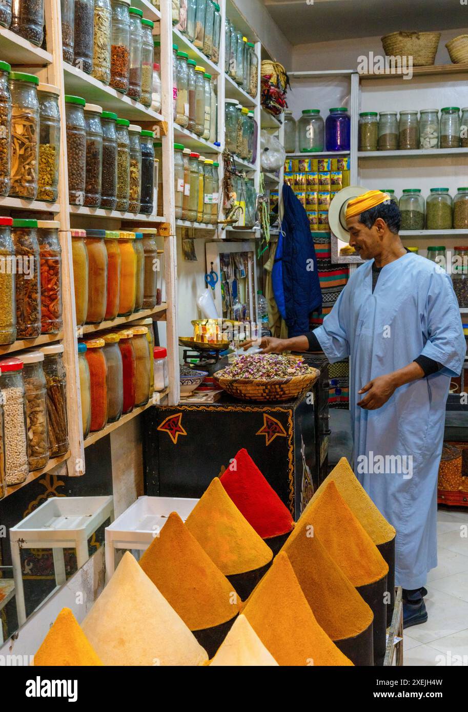 Shopkeeper preparing exotic spices in his store in the souk in the ...