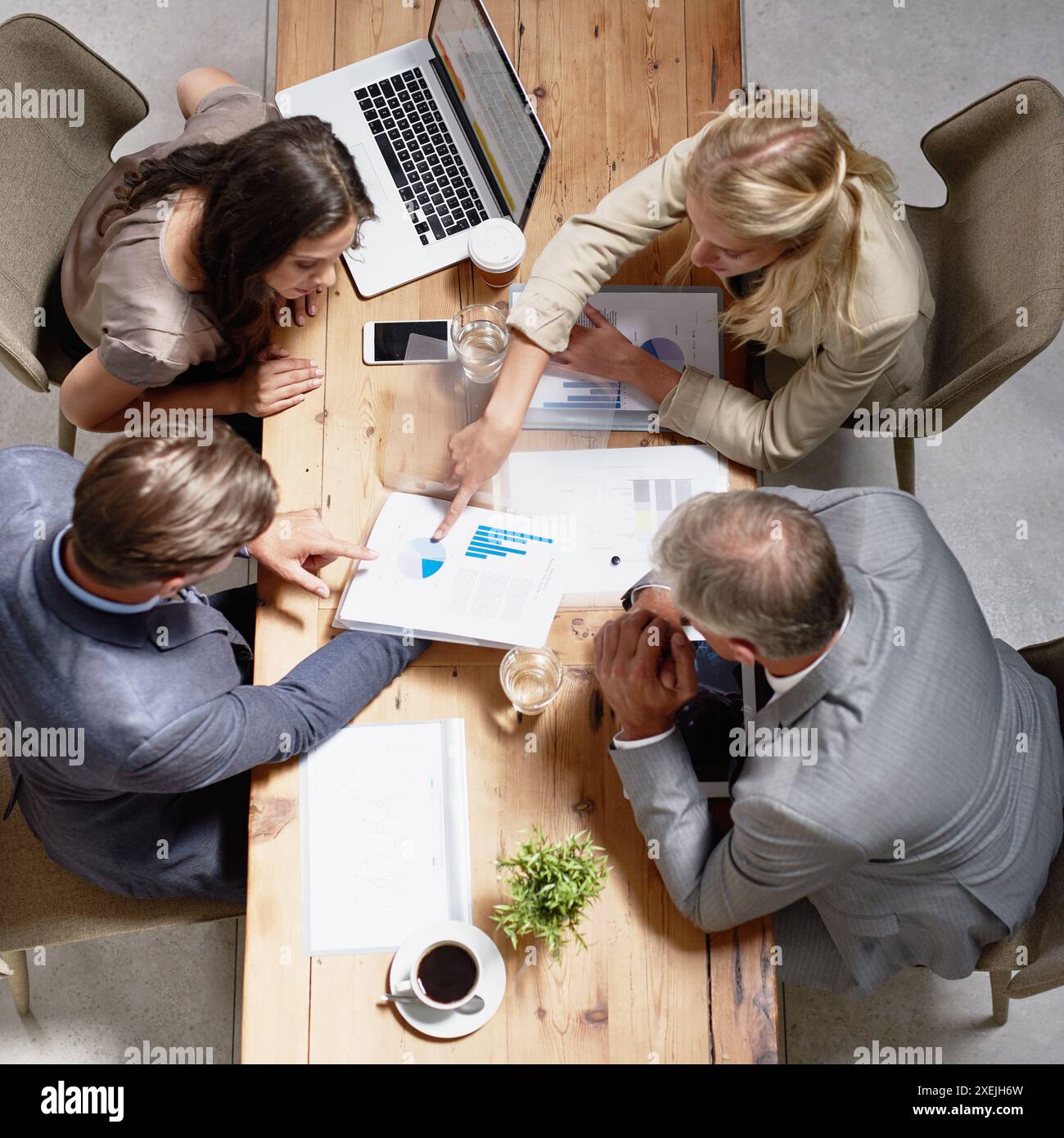 Business people, documents and graphs in meeting, above and discussion with point for financial ...