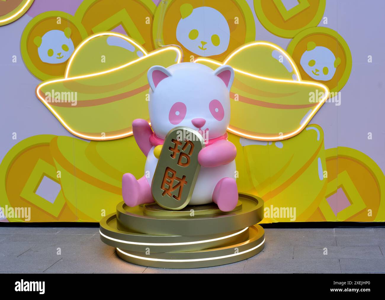 Sitting pink panda holding rectangular gold coin Stock Photo - Alamy