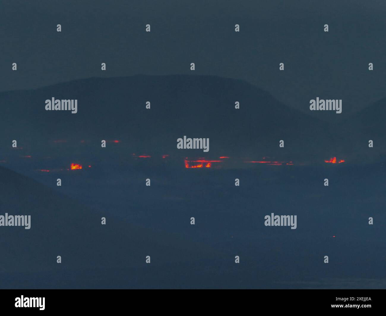 Hazy Icelandic Landscape with Distant Red Glow from Volcanic Eruption ...