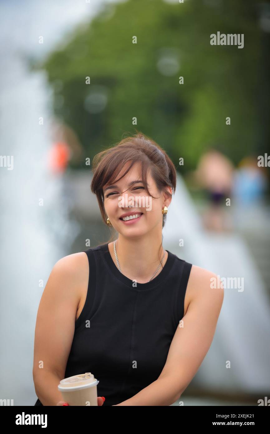 Smiling lady enjoying the aroma of coffee surrounded by the sounds of a ...