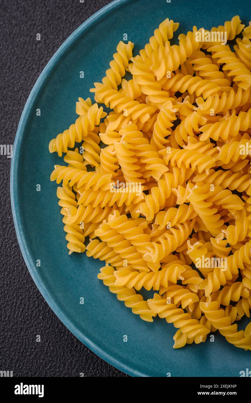 Raw fusilli pasta from whole grain wheat varieties Stock Photo - Alamy