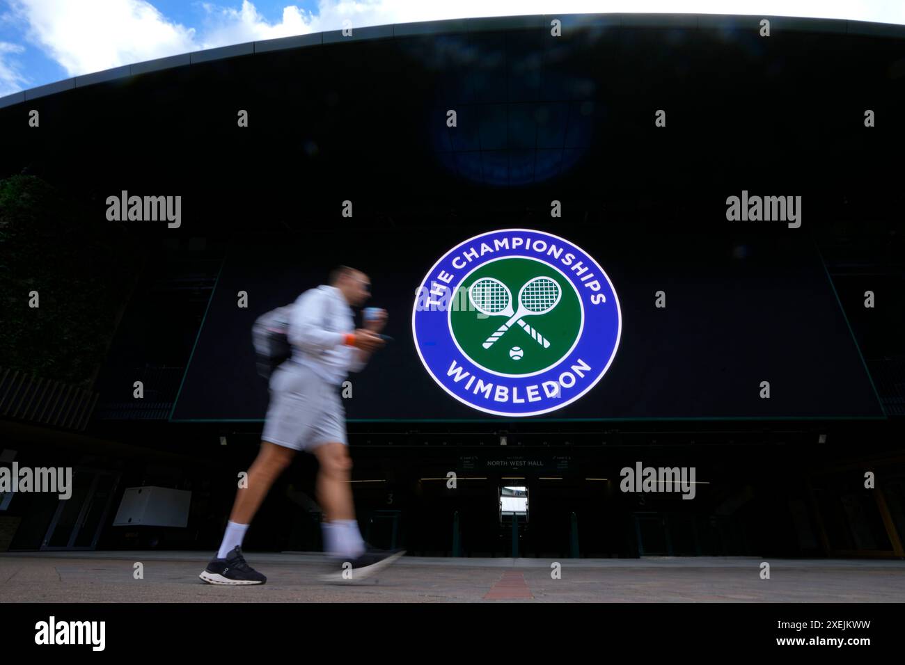 A man passes a sign outside Court One at the All England Lawn Tennis ...
