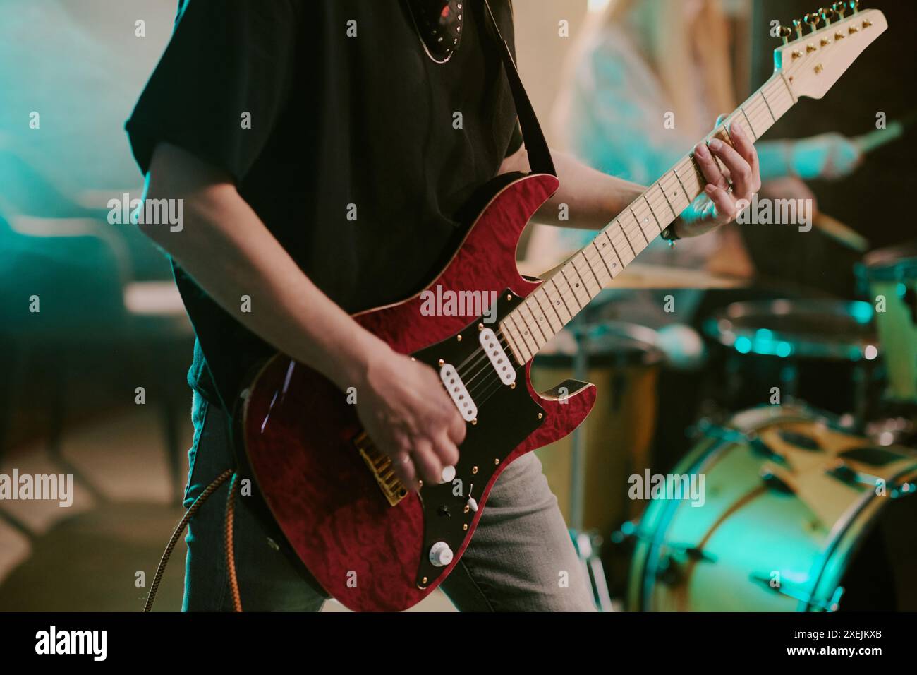 Unrecognizable punk rock musician playing electric guitar in band on ...