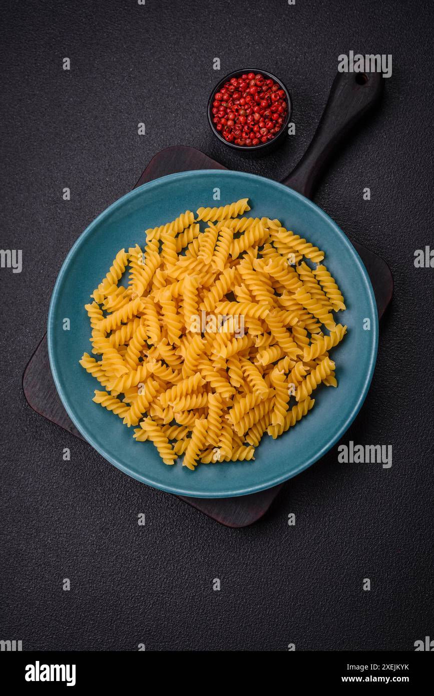Raw fusilli pasta from whole grain wheat varieties Stock Photo - Alamy