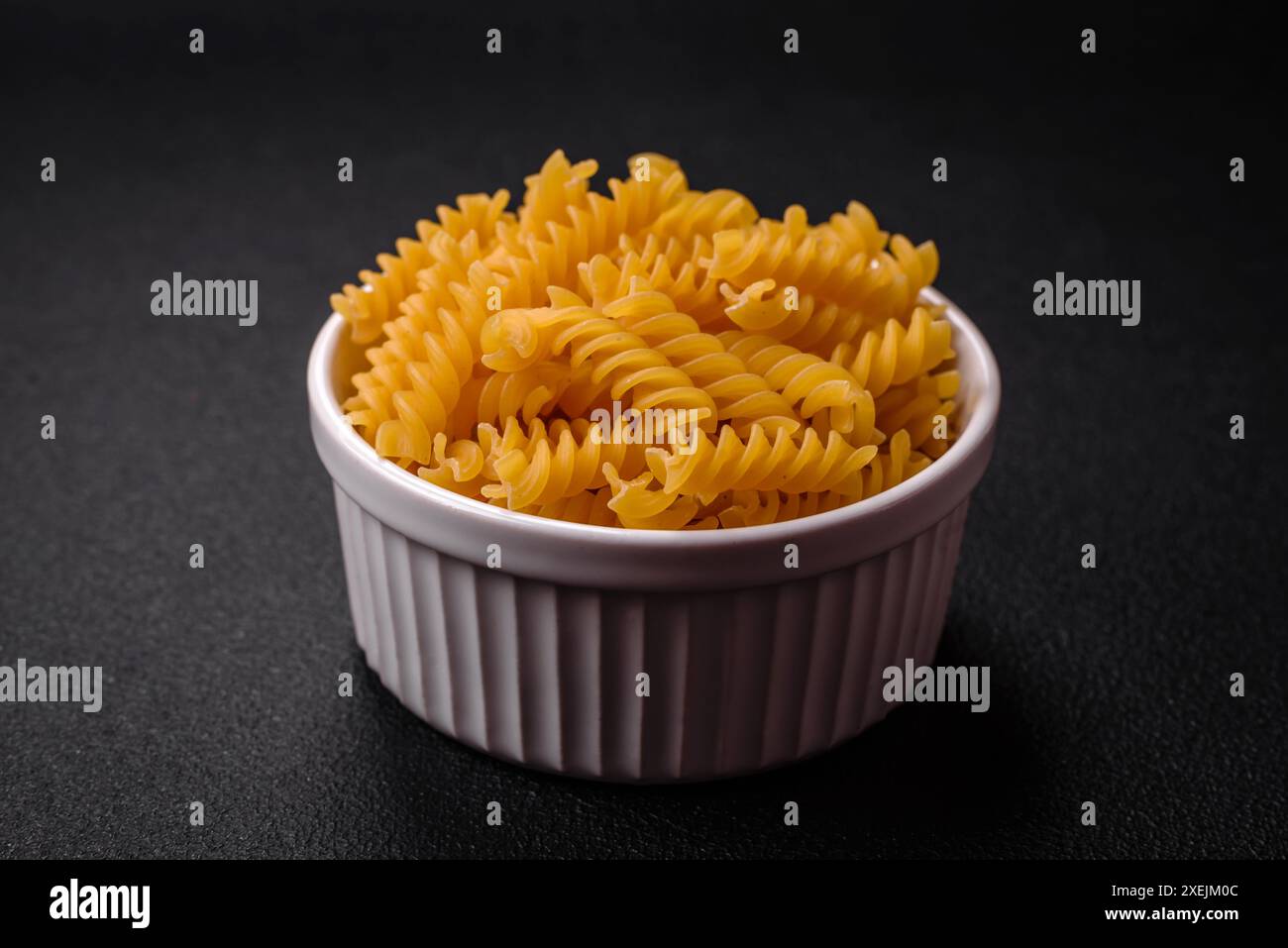 Raw fusilli pasta from whole grain wheat varieties Stock Photo - Alamy