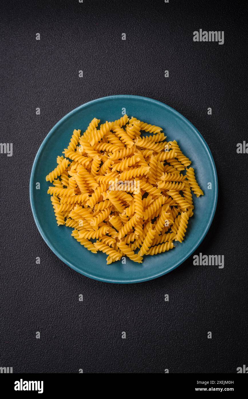 Raw fusilli pasta from whole grain wheat varieties Stock Photo - Alamy