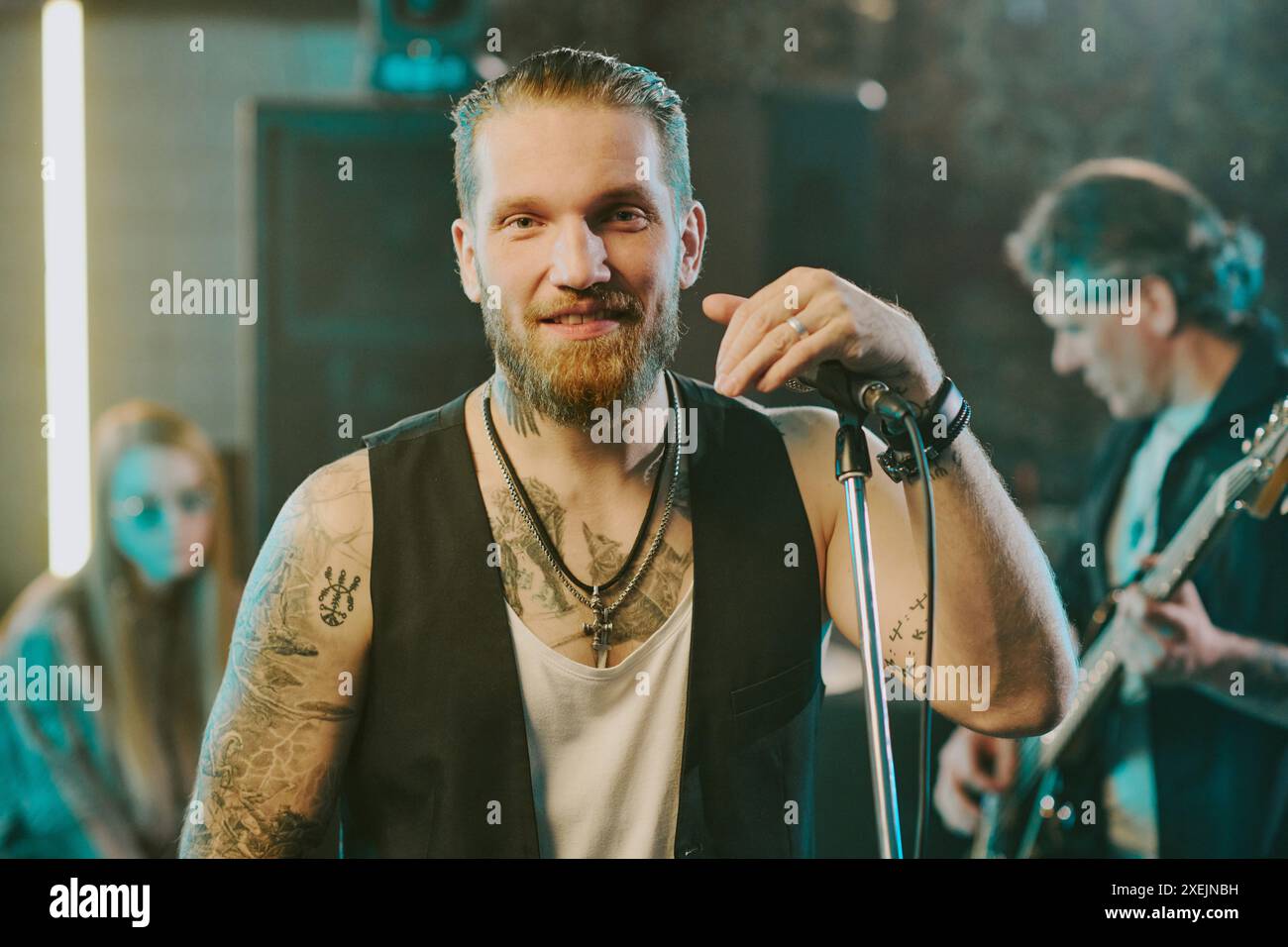 Medium closeup portrait of young Caucasian rock vocalist with beard on ...