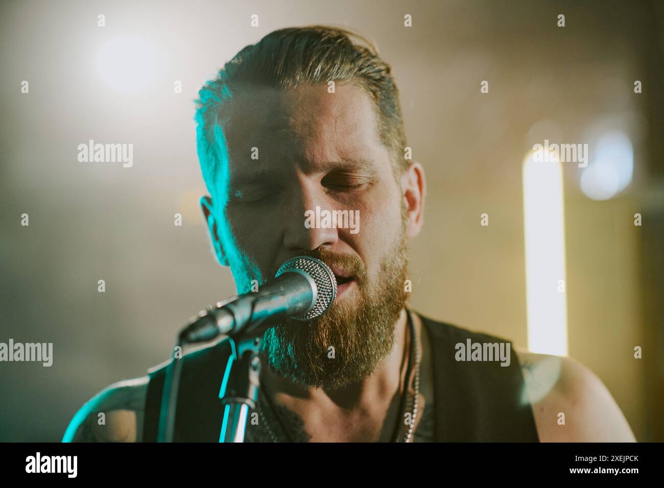Closeup shot of professional rock vocalist singing ballad song with ...