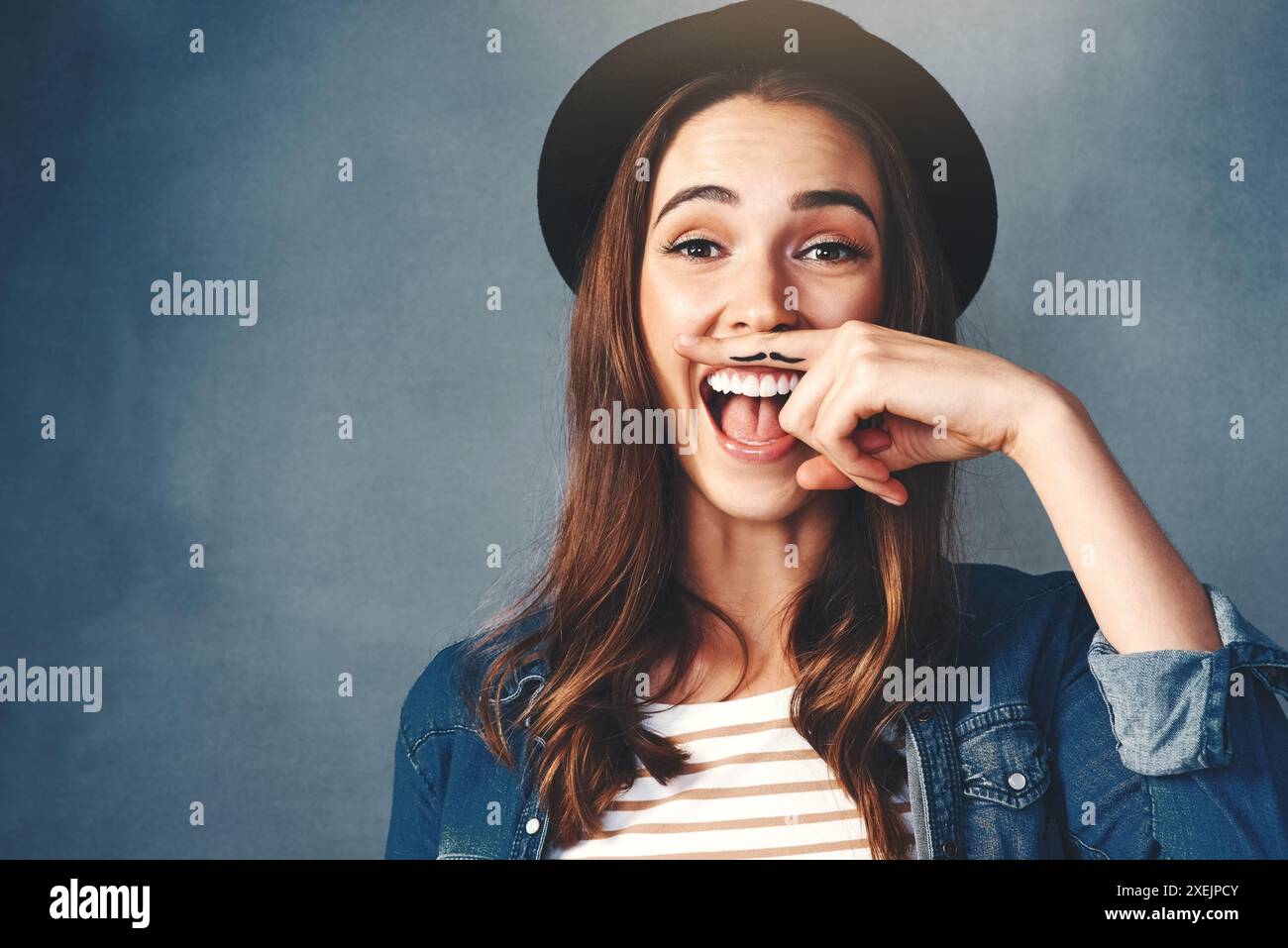 Happy woman, finger and mustache in studio with portrait for quirky ...