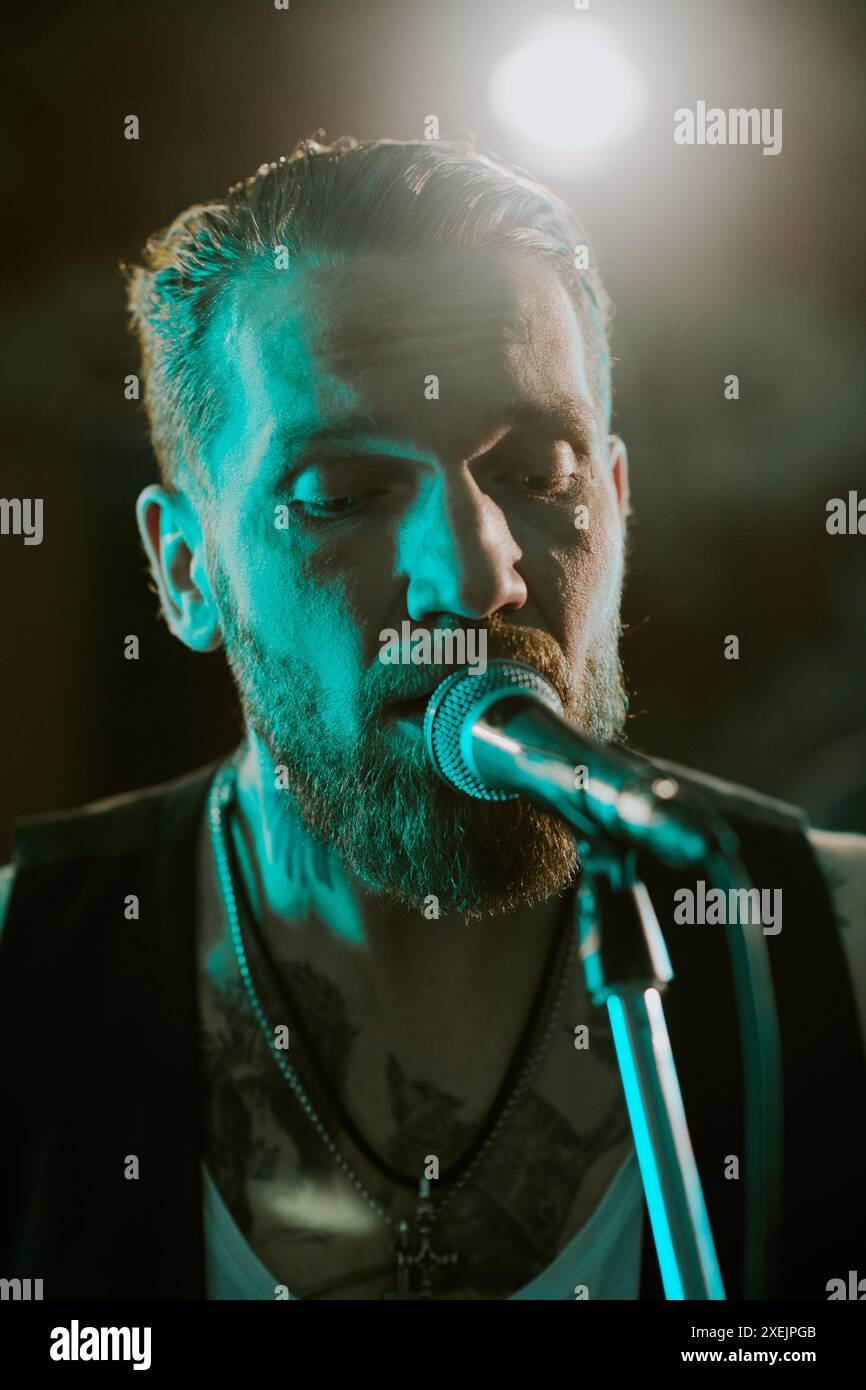 Vertical closeup portrait of bearded gen X rock vocalist singing power ...